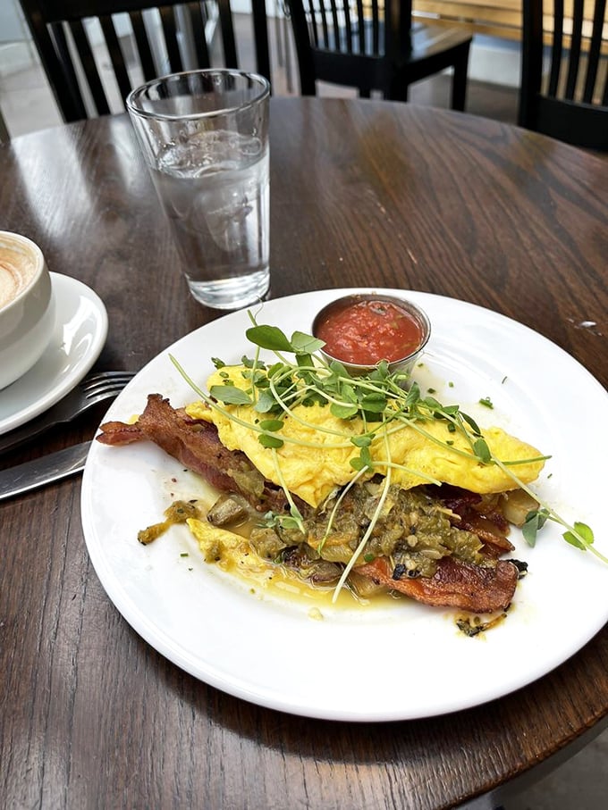 This isn't just an omelet—it's a morning masterpiece with perfectly folded eggs, crispy bacon, and microgreens that actually contribute flavor.