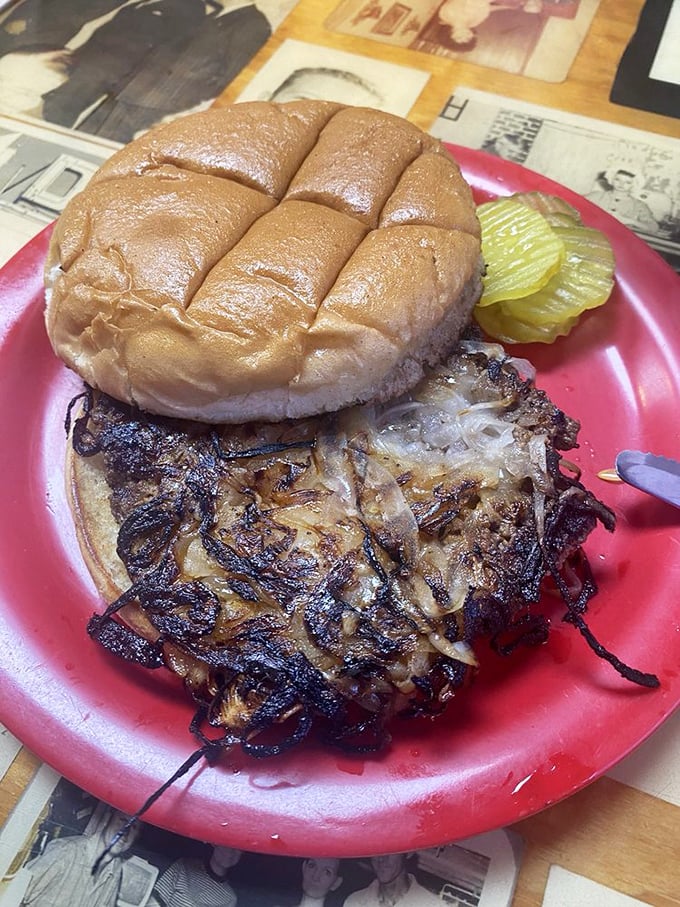 The legendary onion burger in its natural habitat—caramelized onions fused with beef in a marriage so perfect it should have its own reality show.