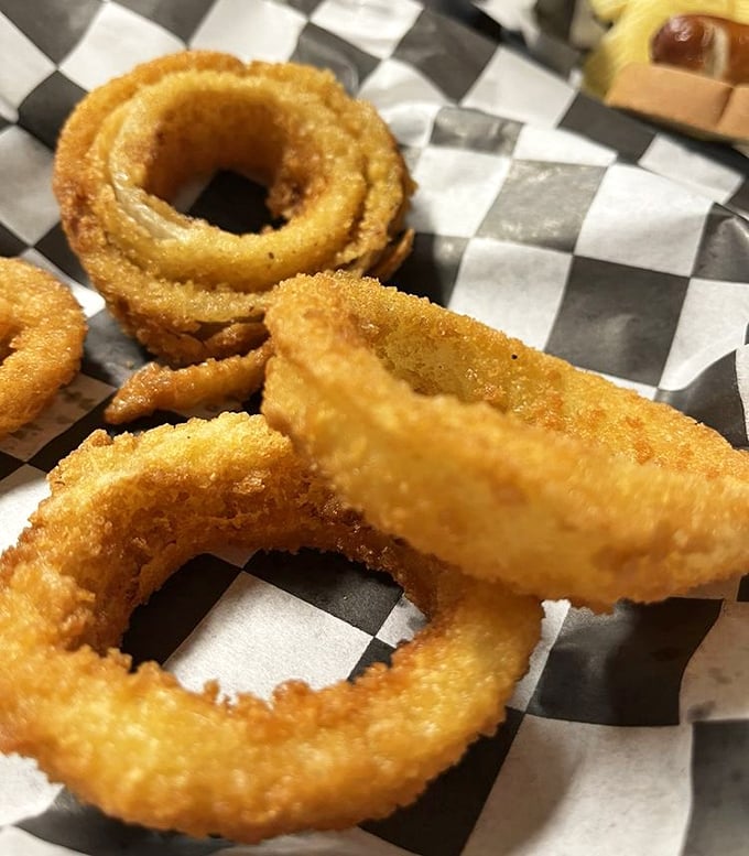 Golden, crispy onion rings that shatter with each bite – the kind that make you wonder why anyone bothers with fancy appetizers when perfection is this simple.