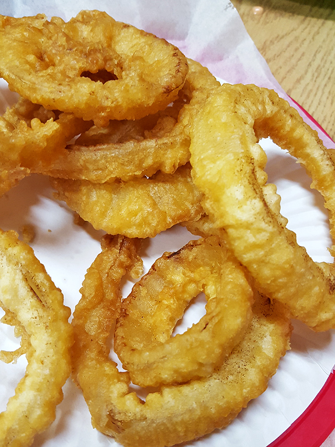 Onion rings that achieve that perfect balance between crispy coating and sweet, tender onion – like edible jewelry for your taste buds.