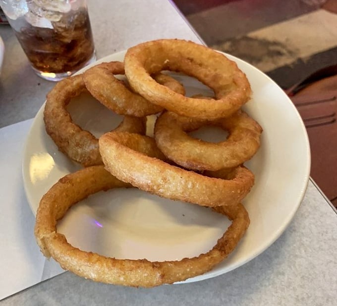 Onion rings that achieve the perfect balance – substantial enough to satisfy, yet light enough that you don't feel like you're wearing them home.