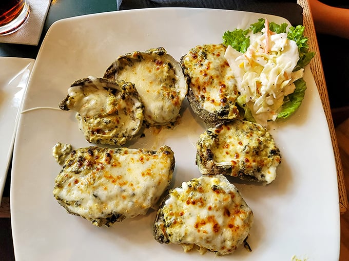 These oysters aren't just baked, they're transformed—wearing a blanket of cheese like it's the finest evening wear at the seafood gala.