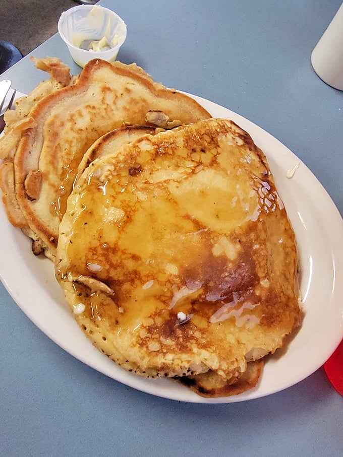 Golden pancakes dripping with syrup and melting butter—the kind that make you wonder why anyone would ever skip breakfast.