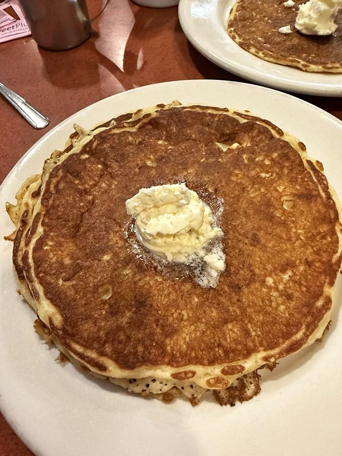 This pancake isn't just large – it's contemplating running for office. The butter melting on top is just casting its vote early.