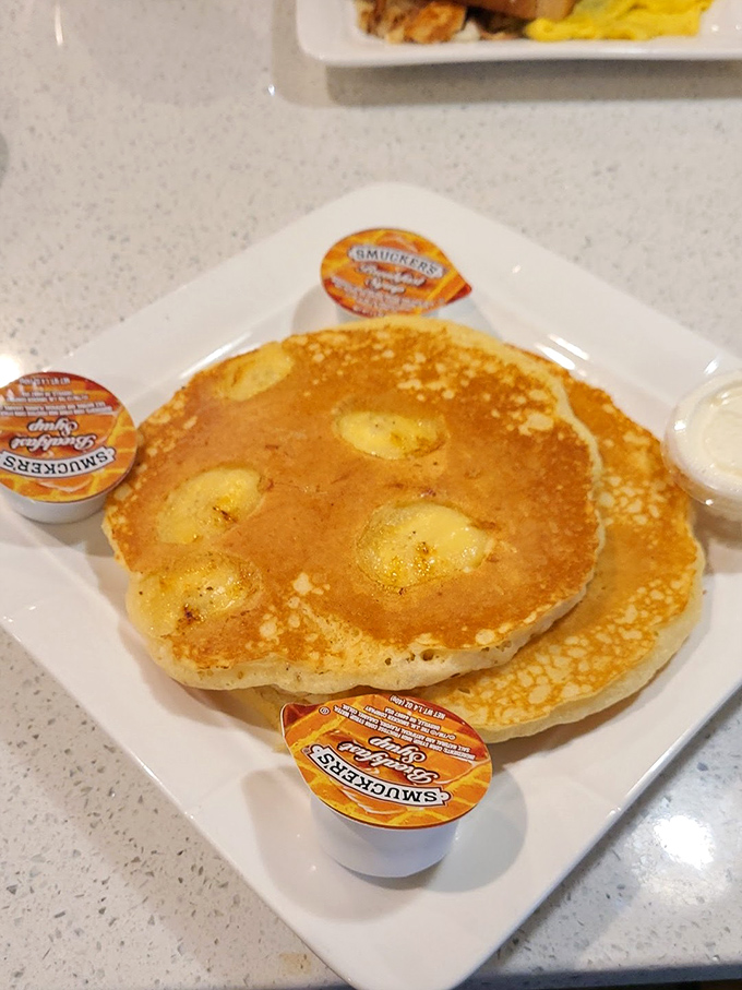 Golden pancakes with pockets of banana goodness—like edible sunshine that somehow makes Monday mornings bearable again.