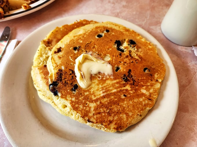 Pancakes with personality! Golden, fluffy discs of joy with melting butter creating little pools of happiness. Maple syrup application pending.