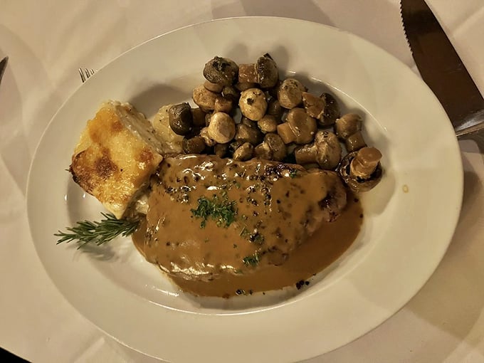 The pepper steak with mushroom sauce is comfort food elevated to art form – those sautéed mushrooms soaking up every drop of that magnificent gravy.
