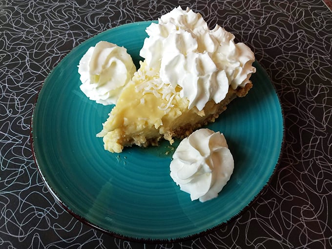 Lemon meringue pie that would make your grandmother simultaneously proud and jealous. Those dollops of whipped cream aren't garnish—they're exclamation points.