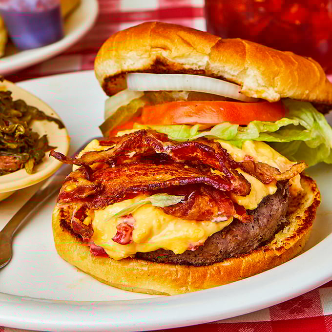 This burger's got more layers than a Tennessee bluegrass ballad – pimento cheese and bacon stealing the show.