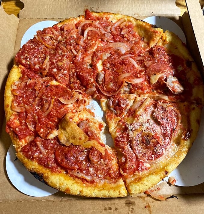 This isn't just pizza – it's a butter-crusted pan masterpiece that makes deep dish devotees question their allegiances. Those caramelized edges don't lie.