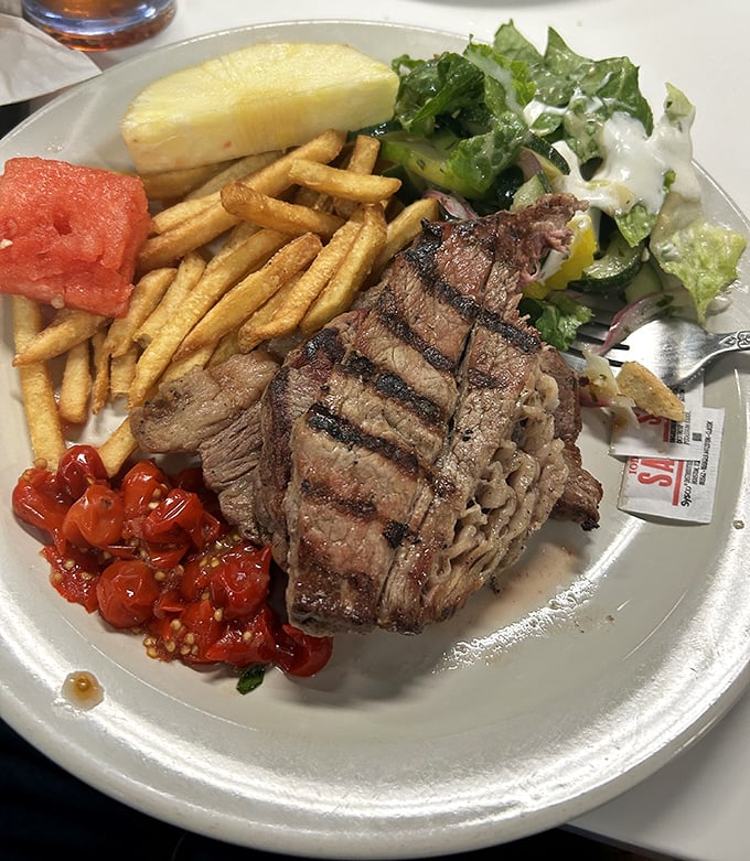 Grilled steak with fresh sides—proof that sometimes the simplest combinations create the most profound food memories.