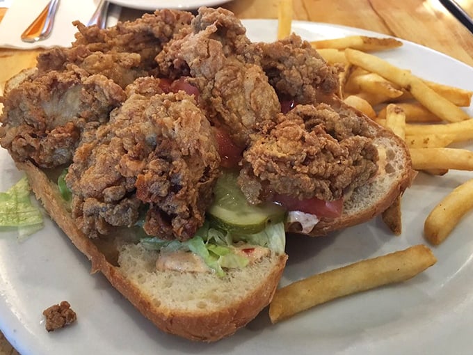 A po' boy that's anything but poor in flavor—fried oysters spilling over the edges of fresh bread with just enough greenery for color.