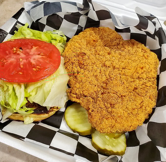 A breaded pork tenderloin that's having an identity crisis as it tries to escape the boundaries of its bun. Pure Hoosier happiness!