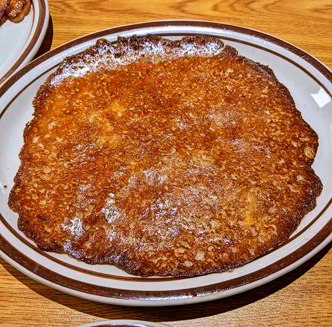 The potato pancake—a golden-brown disc of crispy perfection that puts ordinary pancakes on notice.