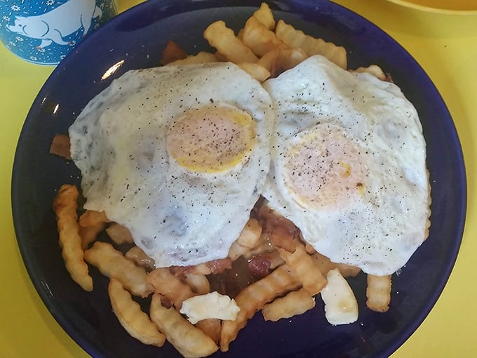 Breakfast rebellion at its finest—crispy fries topped with eggs and what appears to be breakfast meats create a morning poutine worth waking up for.