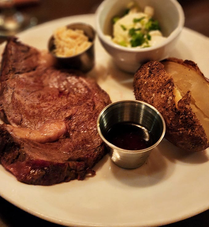 The prime rib doesn't just sit on the plate – it commands attention, flanked by sides that know their supporting role in this meaty masterpiece.