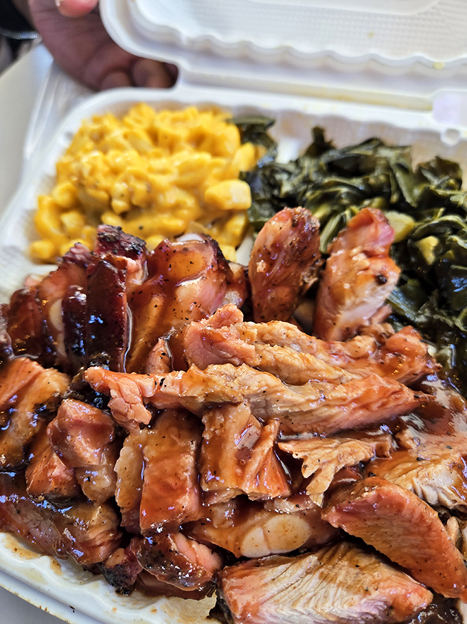 Pulled pork that's had a proper introduction to smoke, paired with mac and cheese and greens—the holy trinity of barbecue companionship.