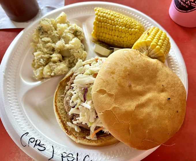 When corn on the cob and mac and cheese join forces with pulled pork, it's not just a meal—it's a Southern symphony on a paper plate.