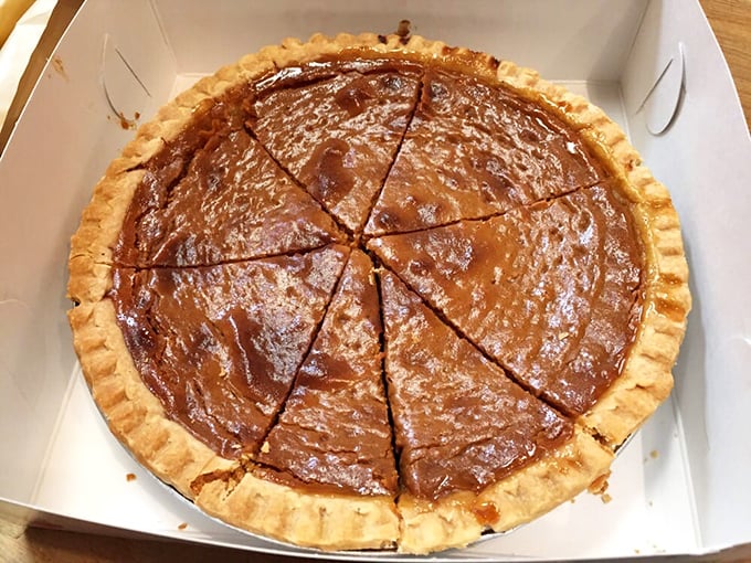 Simple pleasures done right – this crumb-topped pie waits patiently in its box, ready to transform an ordinary day into something special.