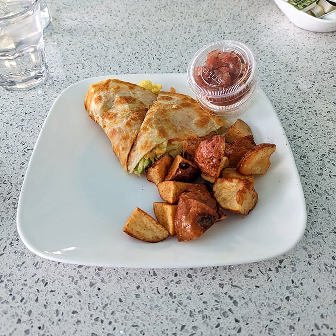 A breakfast wrap that's achieved the impossible: containing its delicious contents while still looking photogenic, with home fries that could make a potato farmer weep with pride.