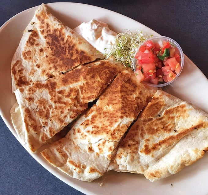 A quesadilla so perfectly grilled it makes you wonder if the chef has a protractor and ruler hidden behind the grill.