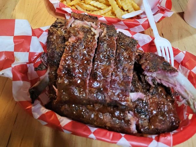 These ribs don't just fall off the bone—they practically leap onto your plate with a bark so perfect it deserves its own Instagram account.