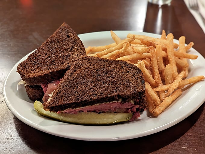 The Reuben sandwich – where pumpernickel, corned beef and sauerkraut perform a perfectly choreographed dance of flavors. Those fries aren't slouching either.