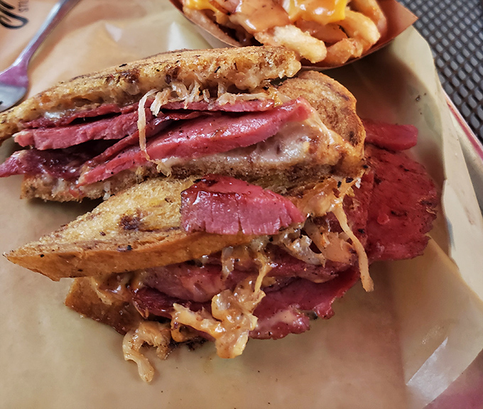This Reuben isn't just a sandwich, it's architecture—layers of corned beef, sauerkraut, and Swiss creating the skyscraper of sandwiches.