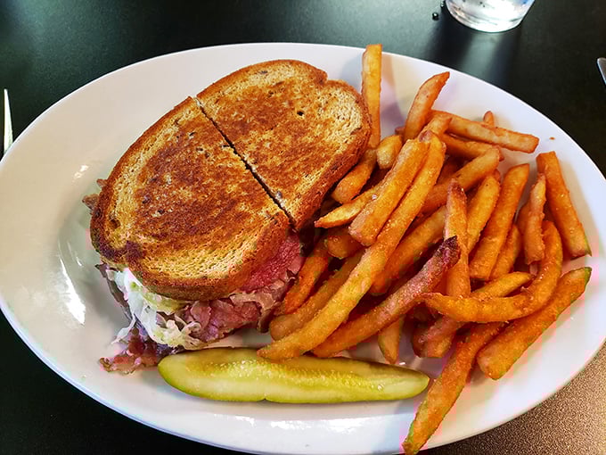 The Reuben sandwich—perfectly grilled rye embracing corned beef, sauerkraut, and Swiss in a harmonious dance. A masterclass in sandwich architecture.