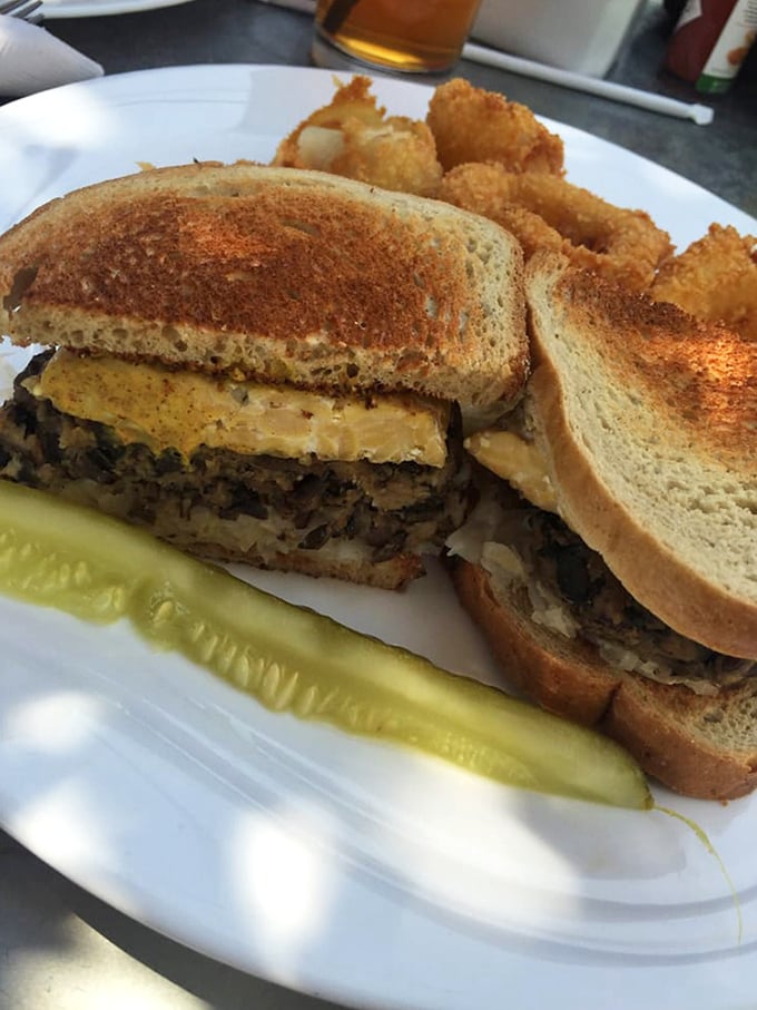The legendary Reuben in its natural habitat – perfectly grilled rye bread housing the perfect marriage of corned beef, sauerkraut, and melted Swiss.