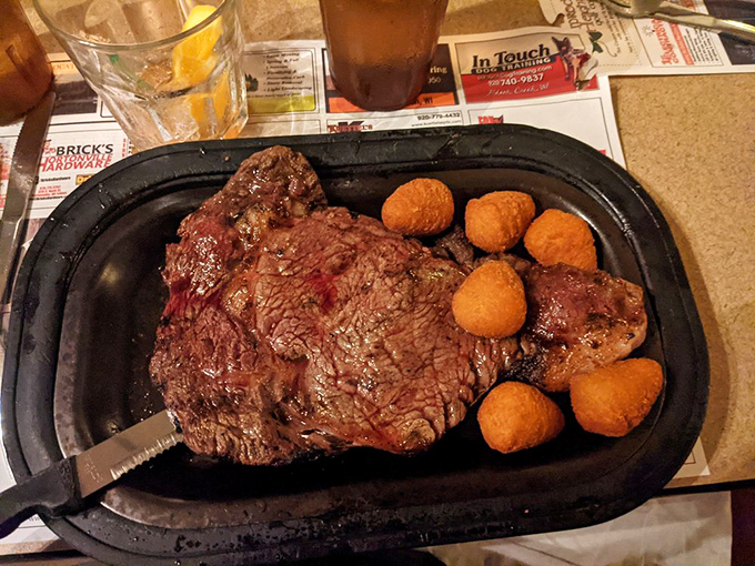 A perfectly seared ribeye with potato puffs standing guard—this plate doesn't need a filter, it needs your undivided attention.