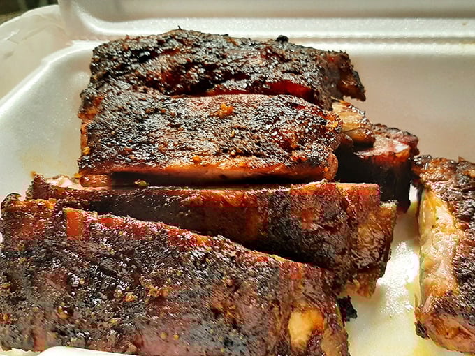 Ribs with a bark so beautiful it belongs in a museum. That smoke ring isn't just pink – it's practically neon with flavor promise.