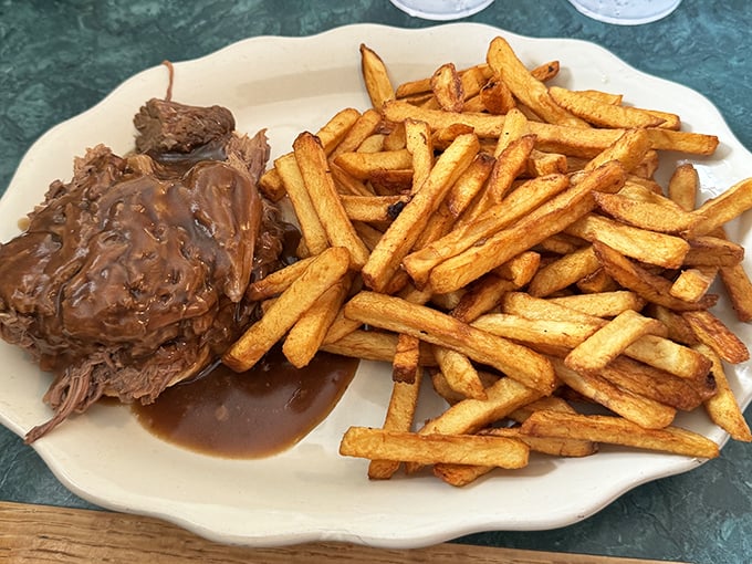 Tender roast beef swimming in gravy alongside golden fries—proof that sometimes the simplest pleasures are the most profound.