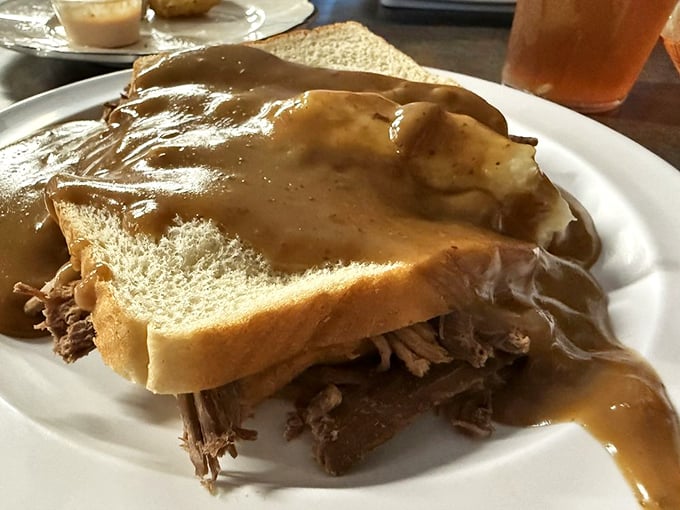 This open-faced roast beef sandwich swimming in gravy isn't just comfort food; it's a warm hug on a plate after a long day.