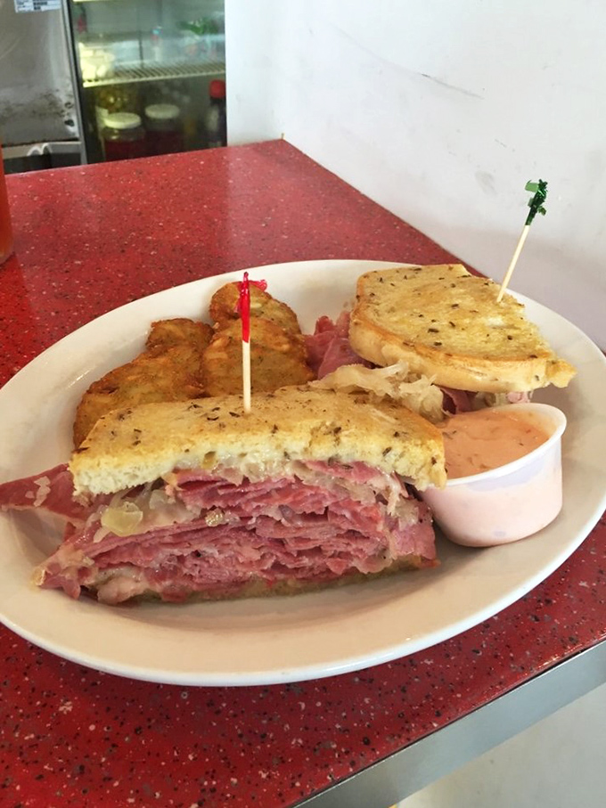 The Reuben reveals its glorious layers like geological strata of deliciousness—corned beef, sauerkraut, and Swiss cheese creating perfect harmony.