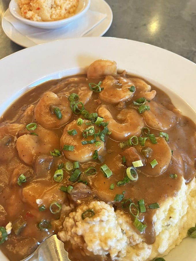 Shrimp and grits so authentic they should come with their own Southern accent—plump shrimp lounging on creamy grits under a blanket of gravy.
