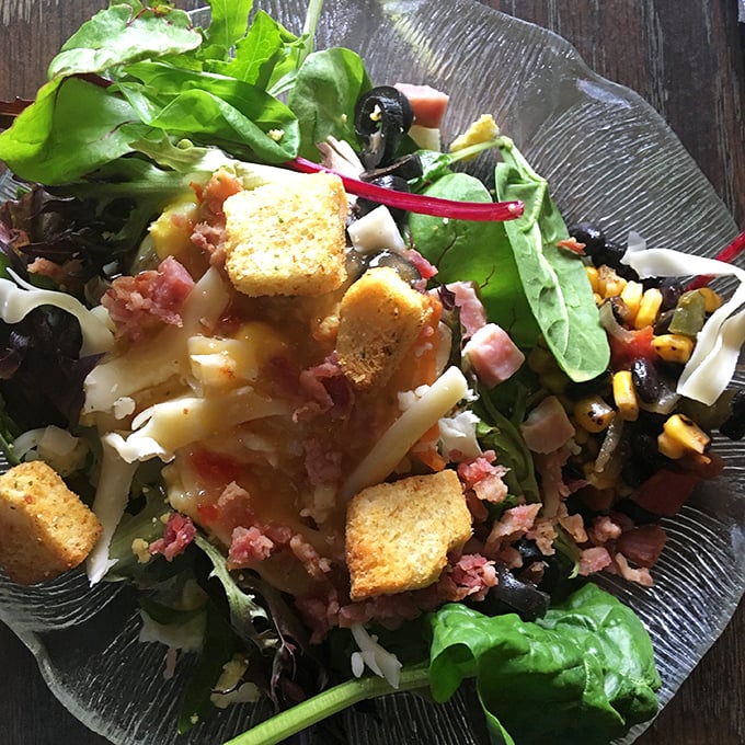 This isn't just a salad—it's a colorful canvas of fresh ingredients, crispy croutons, and savory bits that make vegetables worth celebrating.