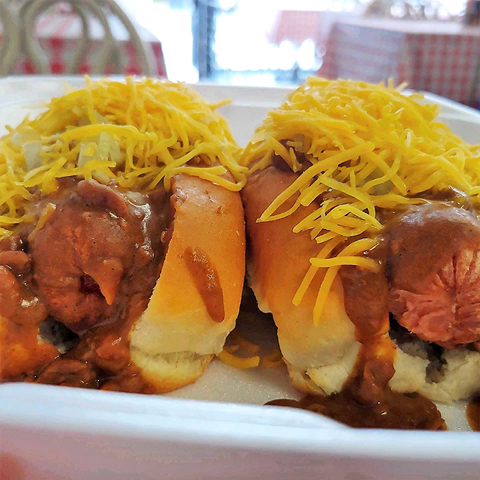 Chili dogs crowned with vibrant yellow cheese—proof that sometimes the most satisfying culinary experiences come without fancy plating or pretentious descriptions.