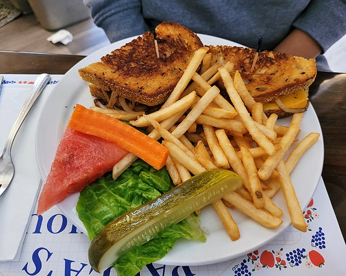 That sandwich towers with melted cheese and comes with a mountain of fries – clearly, moderation isn't in their vocabulary here.