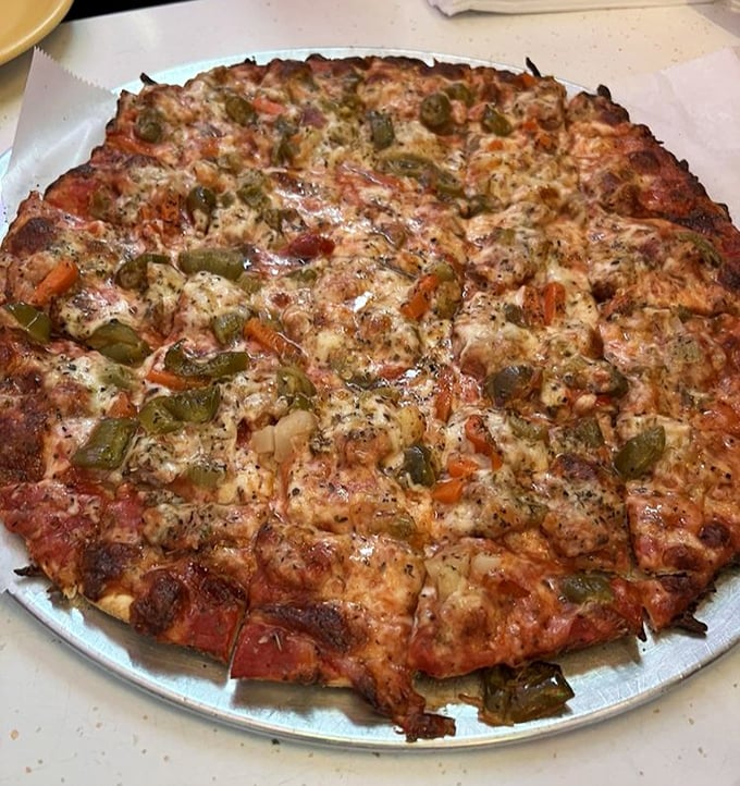 A pizza that doesn't need a passport to Italy—the green peppers and sausage create a neighborhood masterpiece that speaks fluent Chicagoan.