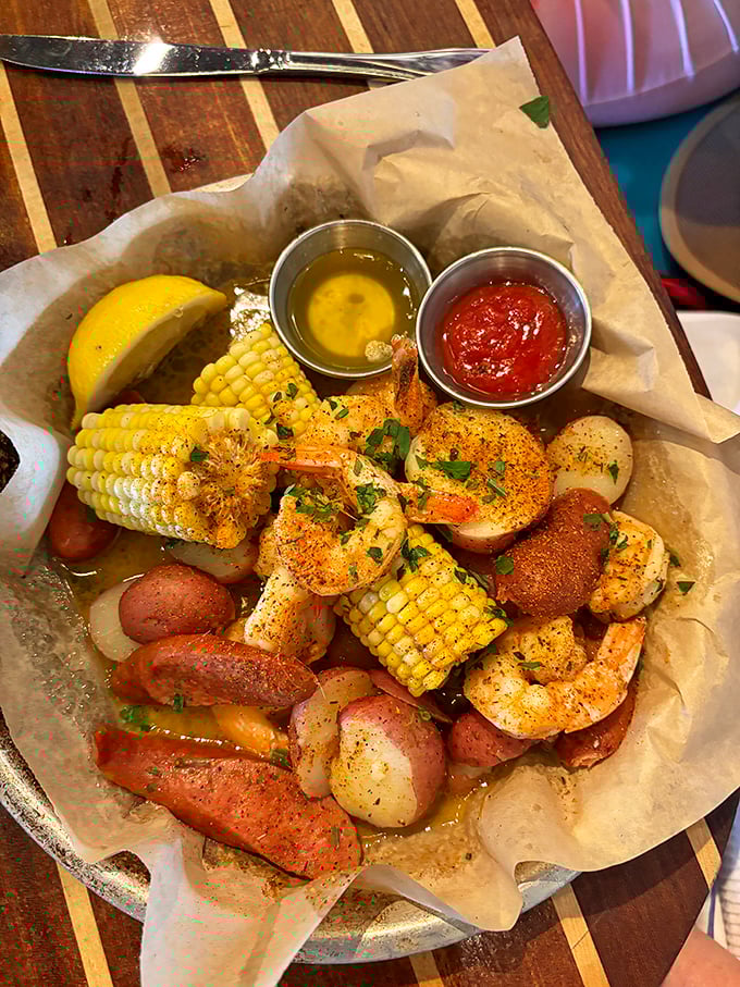 A seafood boil that's practically a party in a basket – plump shrimp, sausage, corn, and potatoes all mingling in seasoned harmony.