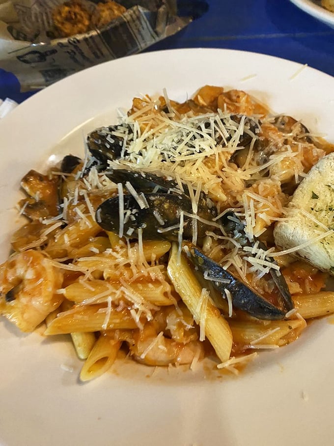 Seafood pasta that doesn't skimp on the good stuff—plump shrimp and mussels nestled among perfectly cooked penne, all crowned with freshly grated parmesan.