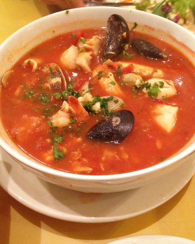 The legendary cioppino—a tomato-based United Nations of seafood. Each spoonful tells a different delicious story of the sea.