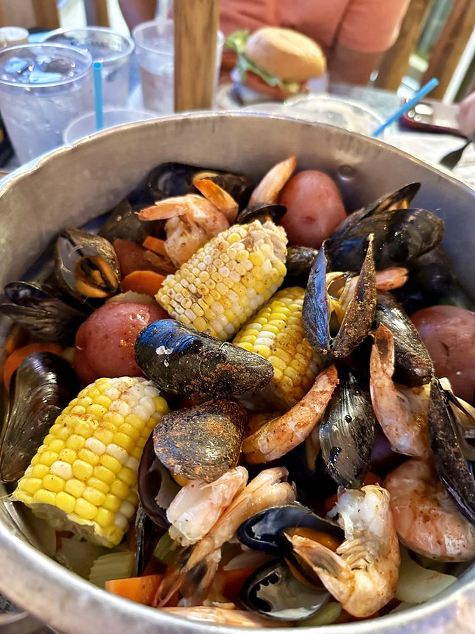The seafood boil arrives like buried treasure—a bounty of ocean delights that'll have you considering a career change to pirate.