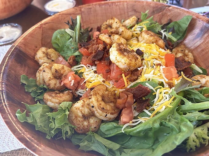 Who knew a salad could look this exciting? Seasoned shrimp perched atop fresh greens with cheese and tomatoes—proof that Louisiana knows how to make even lettuce interesting.