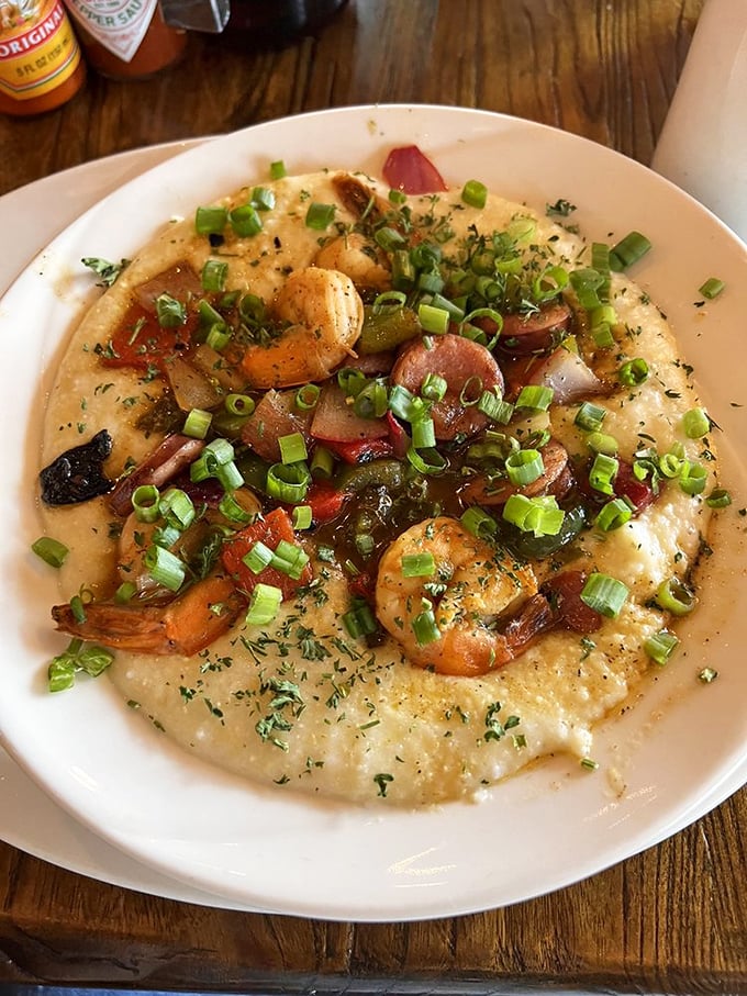 Southern comfort in a bowl—creamy grits providing the perfect canvas for plump shrimp and savory andouille. A spoonful of Tennessee sunshine.