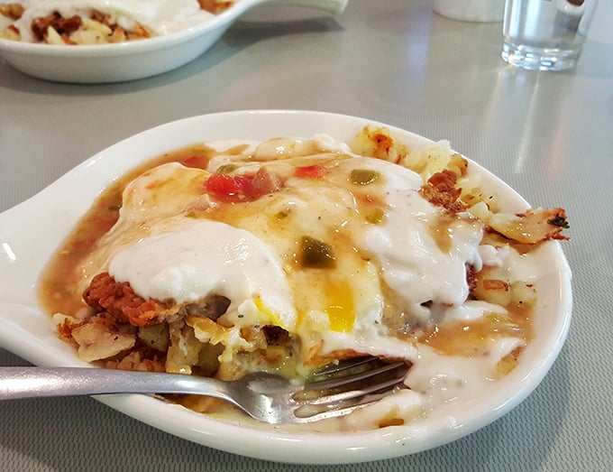 This isn't just breakfast—it's a beautiful disaster of eggs, potatoes, and green chili that would make your cardiologist wince and your taste buds sing.