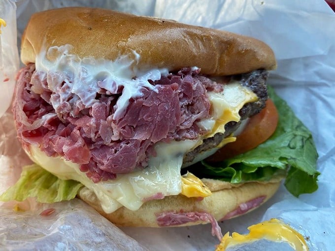 Even the burger gets the Slyman's treatment – a hefty patty topped with enough corned beef to make other burgers feel inadequate.