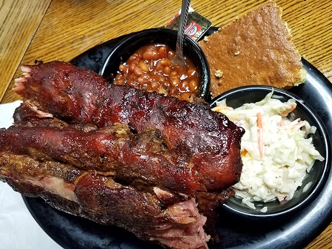 Ribs with that perfect pink smoke ring, flanked by creamy slaw and baked beans – the holy trinity of BBQ perfection.