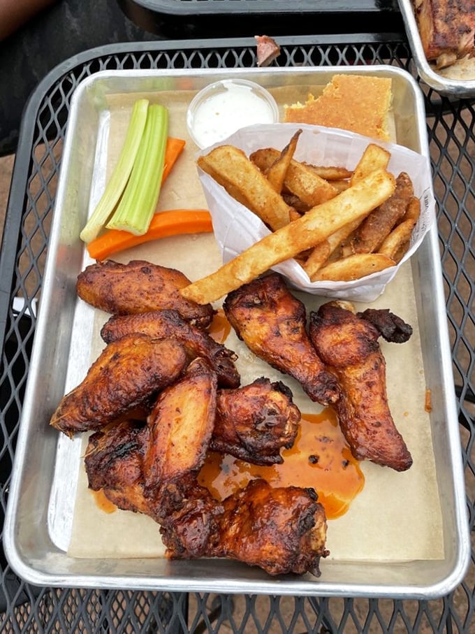 Smoked wings that have clearly been introduced to heat in all the right ways, with fries and cornbread standing by for support.